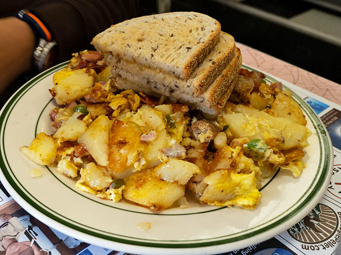 The aptly named "Breakfast Mess" lives up to its reputation—scrambled eggs, home fries, and mix-ins creating a delicious mountain that demands to be conquered.