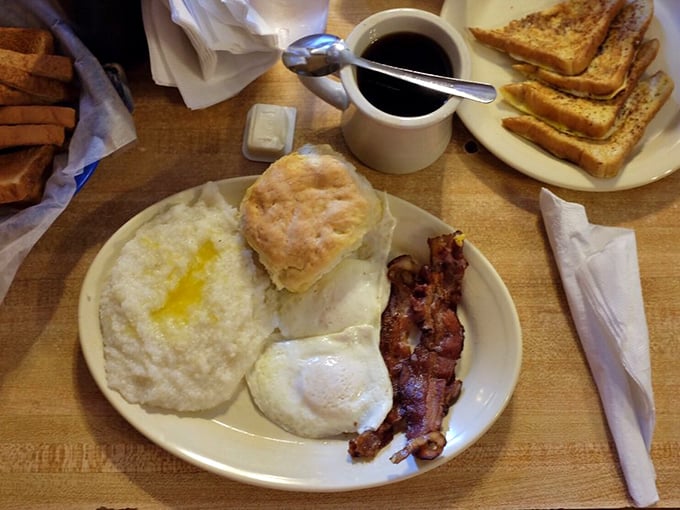 Breakfast nirvana on a plate: perfectly cooked eggs, crispy bacon, cloud-like biscuit, and grits that would make a Southerner weep with joy.