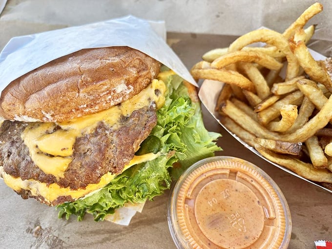 The Standard arrives like a burger superhero&mdash;no cape needed, just perfectly melted cheese cascading down a hand-ground patty alongside golden-brown fries that demand respect.