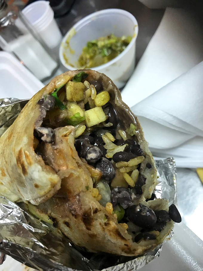 Bean there, done that? Not like this! A perfectly wrapped veggie burrito reveals its treasure trove of beans, rice, and fresh vegetables.