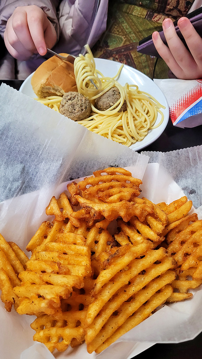 Waffle fries that deserve their own fan club. Golden, crispy lattices of potato perfection that make you question why anyone would eat fries in any other shape.
