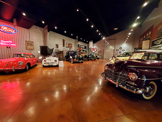 The showroom gleams with automotive royalty. That red beauty on the left? She's not just a car&mdash;she's the prom queen of the petroleum age.