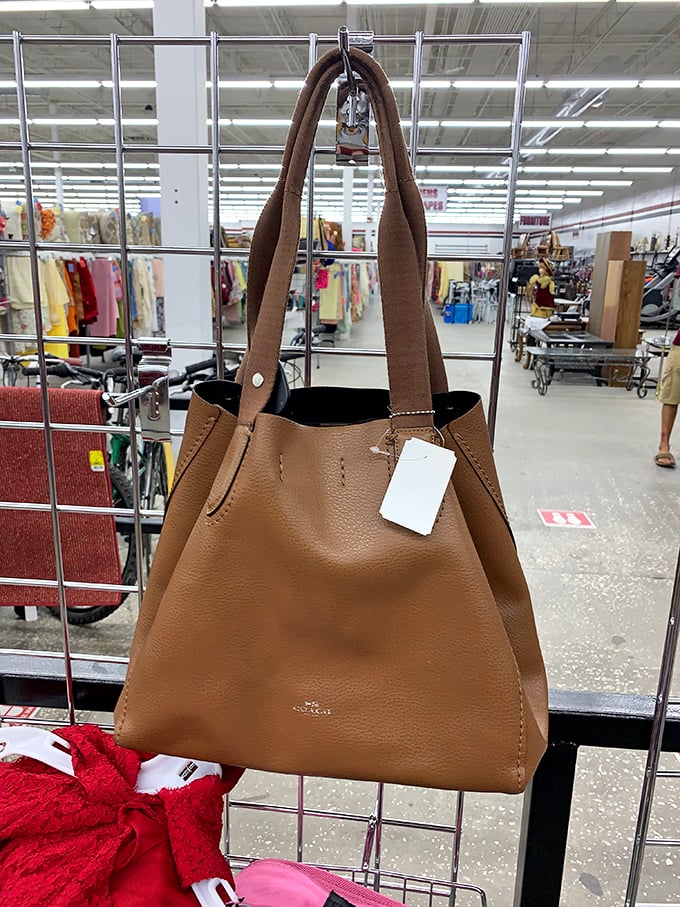 Designer dreams at thrift store prices! This leather tote bag with its pristine tag is the kind of find that makes dedicated thrifters do a little victory dance in the aisle.