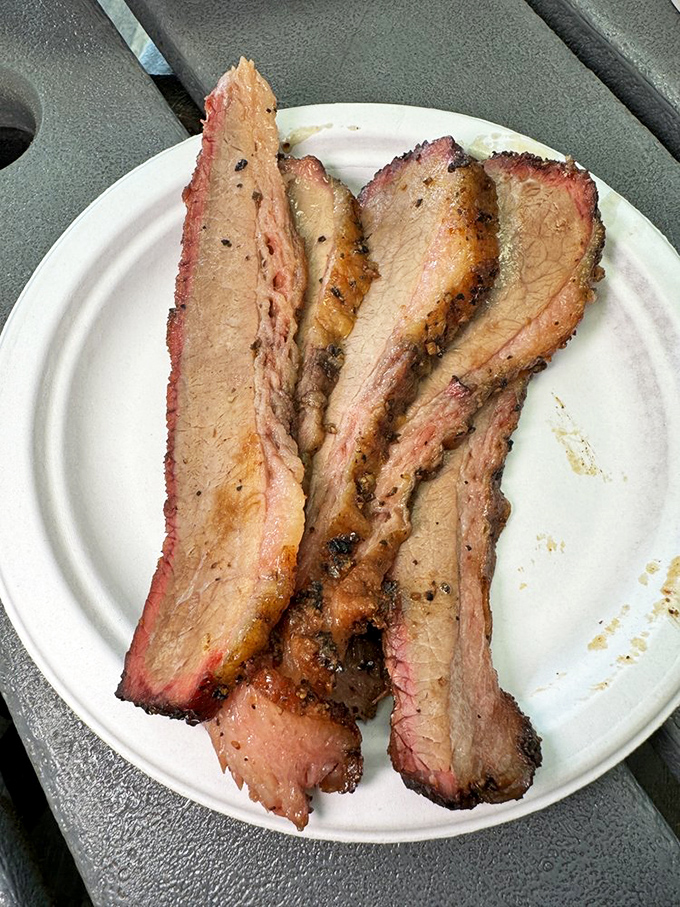 Brisket slices with that telltale pink smoke ring &ndash; barbecue's equivalent of Olympic gold. Each piece tells a story of patience and fire.