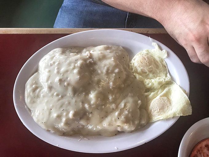 This country-fried steak swimming in pepper-flecked gravy isn't just breakfast&mdash;it's therapy on a plate, with eggs standing by for moral support.