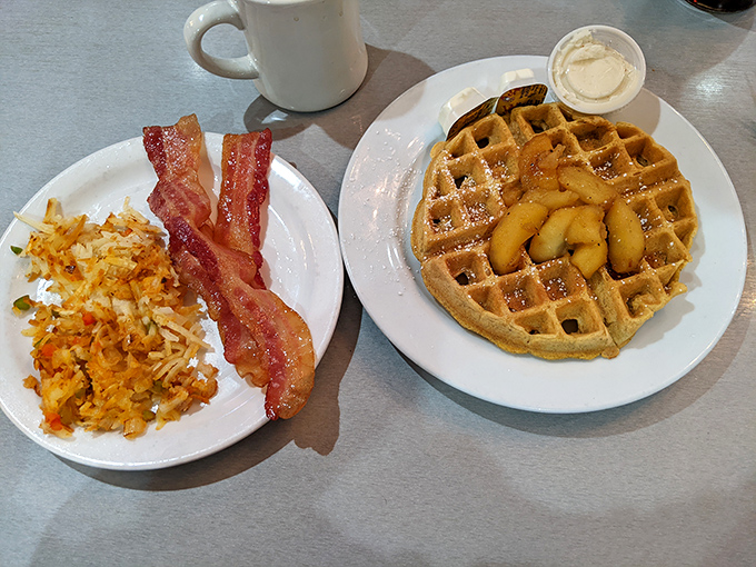 Breakfast nirvana: golden hash browns, perfectly crisp bacon, and a waffle that's practically begging for its maple syrup bath.