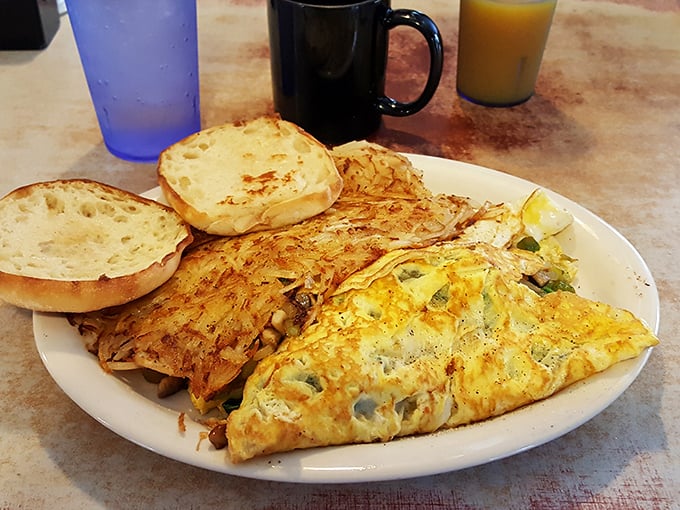 Breakfast perfection doesn't need fancy plating—just a well-executed omelet, crispy hash browns, and English muffins waiting for their butter bath.