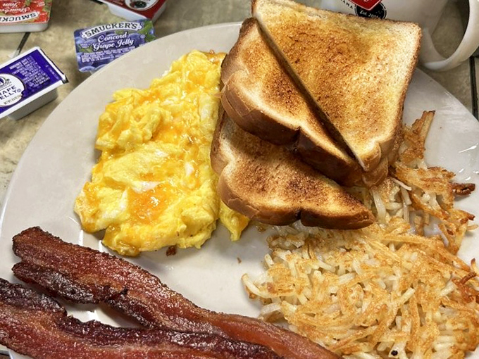 Breakfast perfection on a plate: scrambled eggs that would make a French chef weep, toast with that ideal butter-to-crunch ratio, and bacon that should have its own fan club.