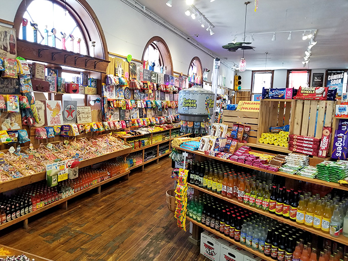 Beneath beautiful arched windows, shelves of rainbow-hued treats create a kaleidoscope effect that would make even the most disciplined dietitian temporarily suspend judgment.