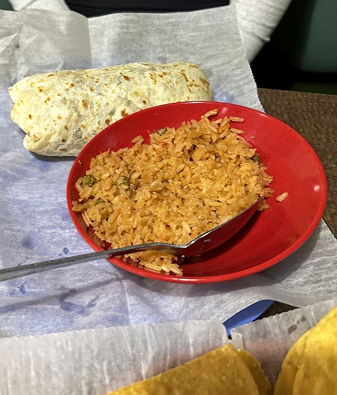 Behold the burrito in its natural habitat&mdash;wrapped in foil, accompanied by perfectly seasoned rice, ready to transport you to flavor country without a passport.