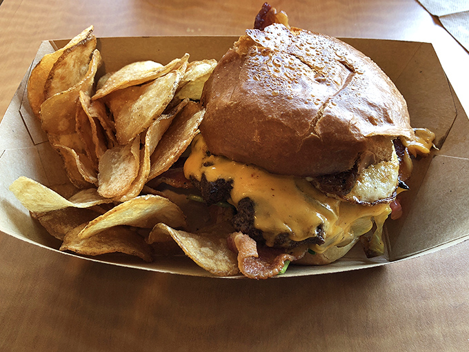 Not all heroes wear capes—some come in burger form with a mountain of house-made chips standing guard.