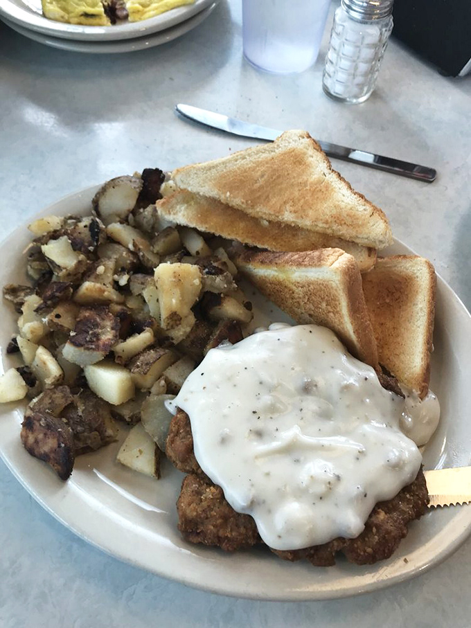 This isn't just chicken fried steak&mdash;it's edible nostalgia, smothered in pepper gravy that could make your grandmother both jealous and proud at the same time.