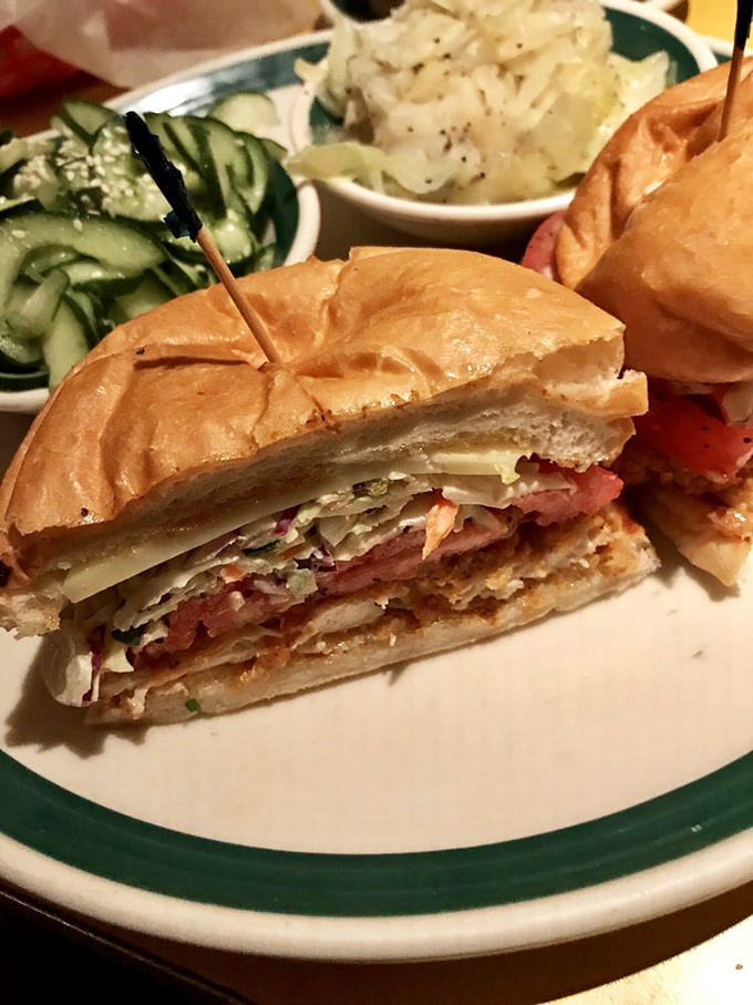 This isn't just a sandwich; it's an architectural masterpiece of layers that would make Frank Lloyd Wright put down his blueprints and pick up a fork.