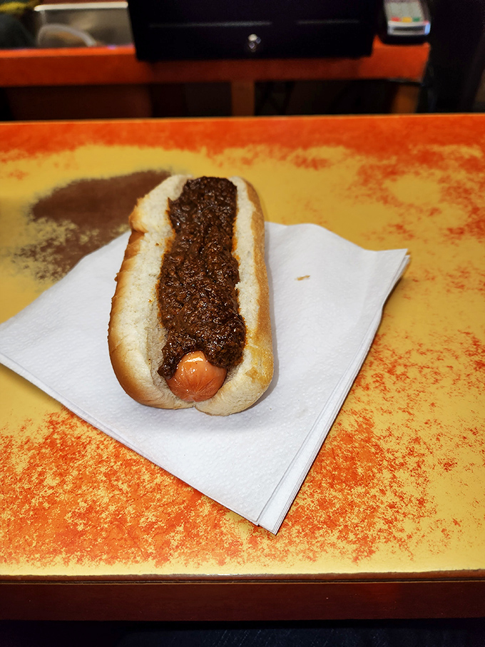 Simplicity perfected: a classic chili dog resting on the Squeeze-In's signature orange-speckled countertop. Sometimes the most basic pleasures are the most satisfying.