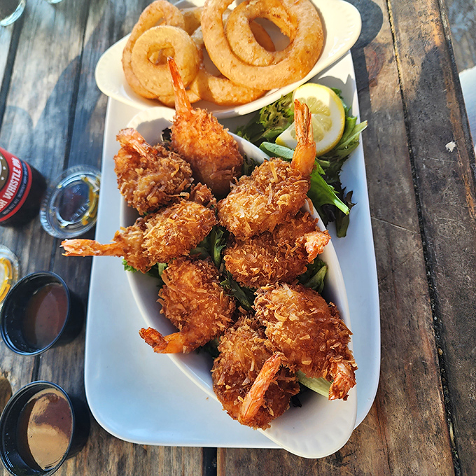Golden-brown coconut shrimp that could make a mermaid trade her tail for legs just to taste these crispy treasures.