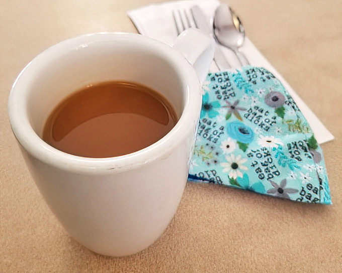 That sturdy white mug holds liquid motivation&mdash;honest diner coffee that doesn't need fancy names or artistic foam to get the job done.