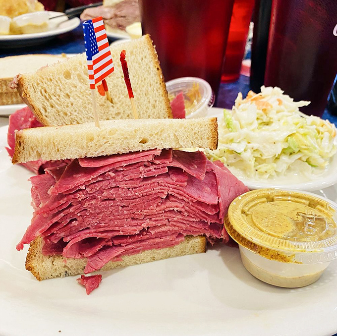 The corned beef sandwich stands tall and proud, like the Statue of Liberty if she were made of delicious, thinly-sliced meat. The American flag toothpick is just showing off.