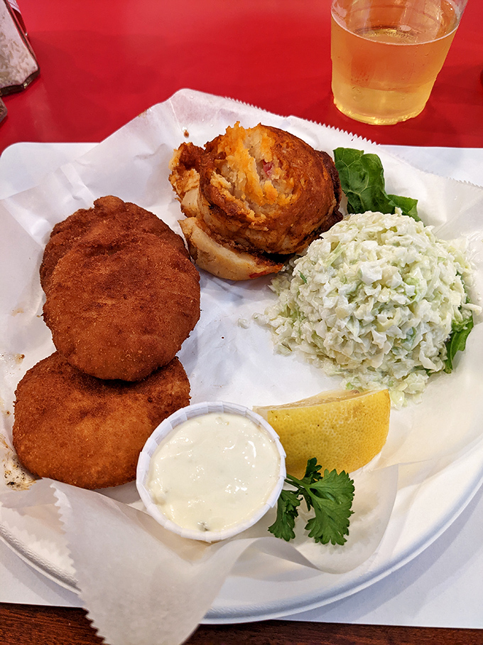 Golden crab cakes paired with crisp coleslaw &ndash; comfort food that makes your taste buds do a happy dance. 