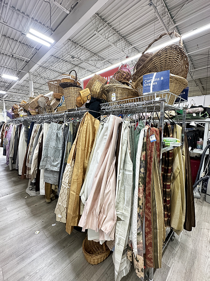 Curtains and baskets galore! Above the clothing racks, woven treasures await the shopper willing to look up from the fashion hunt.