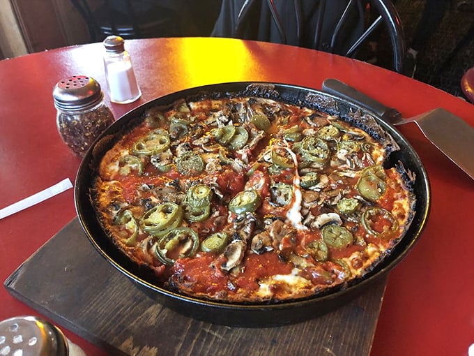 Pizza architecture at its finest&mdash;layers of toppings, chunky sauce, and that signature blackened cheese perimeter that's worth crossing state lines to experience.