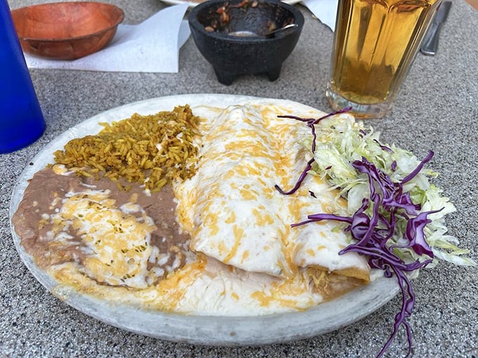 This isn't just an enchilada&mdash;it's a cheese-blanketed revelation served with perfectly seasoned rice and beans that refuse to be mere sidekicks.