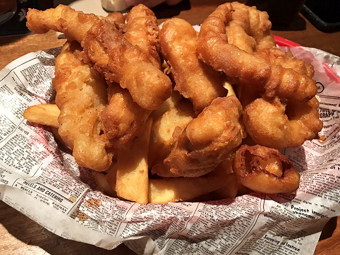 Golden-battered fish pieces stacked like delicious Jenga blocks atop thick-cut chips. One wrong move and you'll have to eat the evidence!
