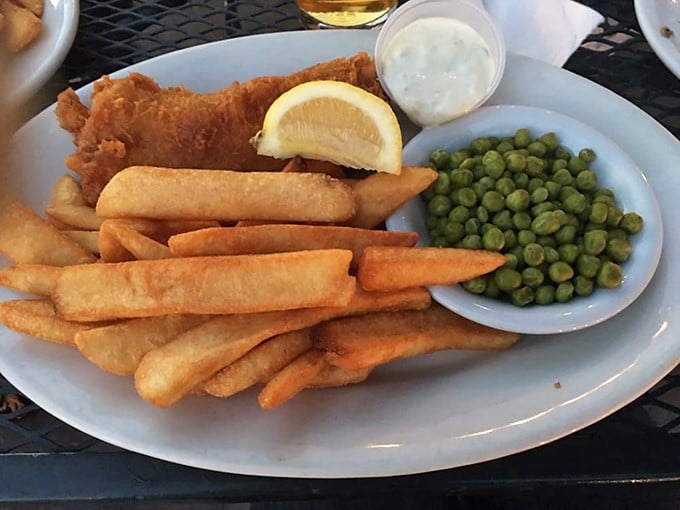 Fish and chips done proper&mdash;golden-battered fish, chunky chips, and those vibrant mushy peas that look suspiciously healthy amid all that delicious indulgence.