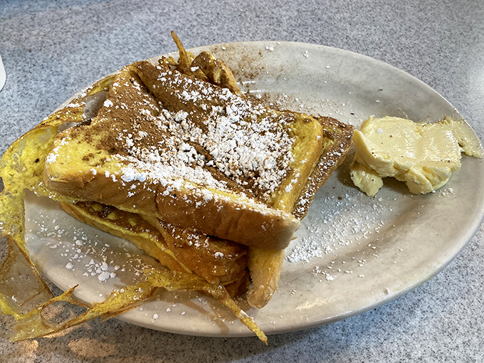French toast that's achieved celebrity status. Dusted with powdered sugar and served with a side of butter that's melting just looking at it.