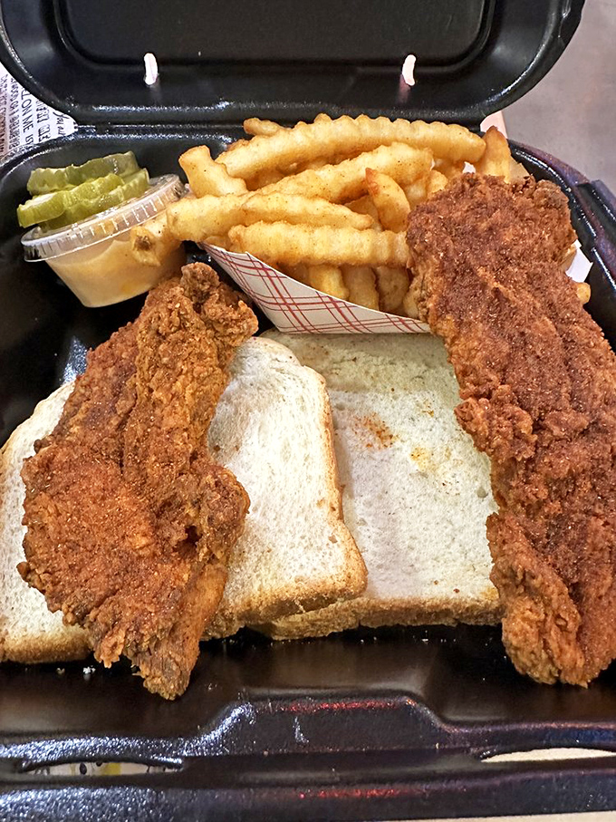 This isn't just a sandwich; it's an architectural masterpiece of crispy chicken, pillowy bread, and pickle coins that would make Frank Lloyd Wright weep with joy.
