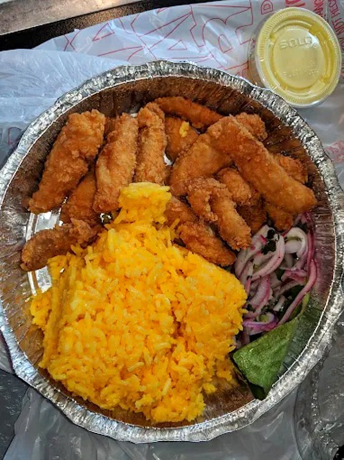 Golden fried chicken tenders nestled against saffron-hued rice with a splash of red onion salsa. Simple ingredients transformed into something extraordinary.