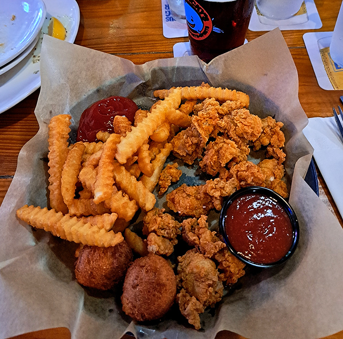 A basket of golden-fried treasures that makes sharing feel like a moral dilemma. Those crinkle fries are practically begging for a dip.