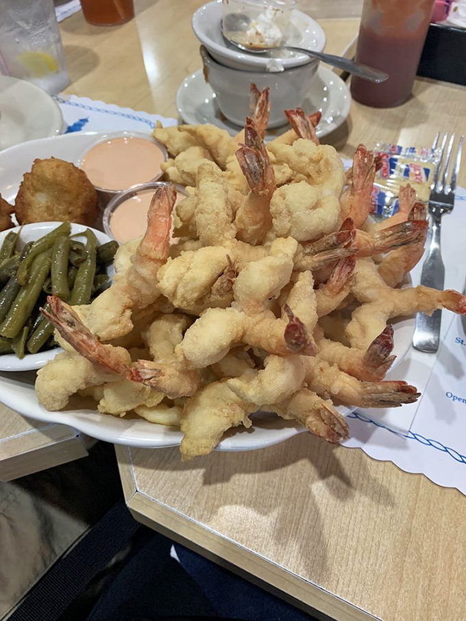 Golden fried shrimp piled high like treasure from the sea, paired with green beans that somehow don't feel like penance.