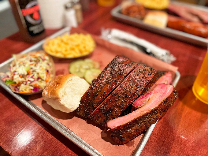Behold the half rack of ribs in all their bark-crusted glory. That pink smoke ring isn't just pretty&mdash;it's a PhD in patience.