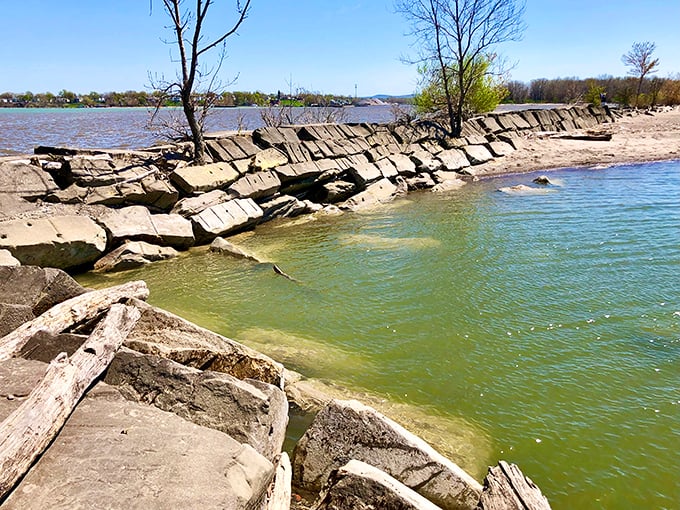 Nature's architecture meets human engineering where jagged rocks and gentle waters create a frame for Fairport Harbor's coastal charm.