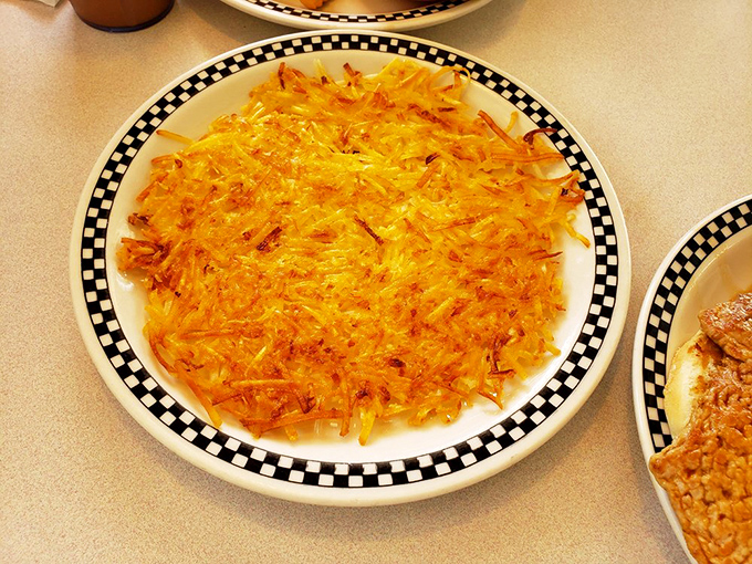 Golden, crispy hash browns that audibly crunch with each bite. The checkerboard plate is just letting you know you've made a winning breakfast move.