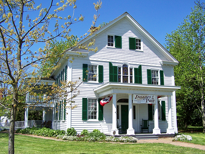 This pristine white colonial with emerald shutters houses "Images of the Past," though it looks ready for a modern-day garden party that Gatsby would approve of.