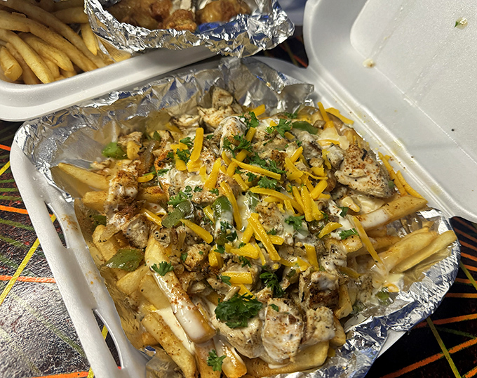 Loaded fries that require a game plan. This cheesy, herb-sprinkled masterpiece demands strategic eating&mdash;do you save the gooiest parts for last?