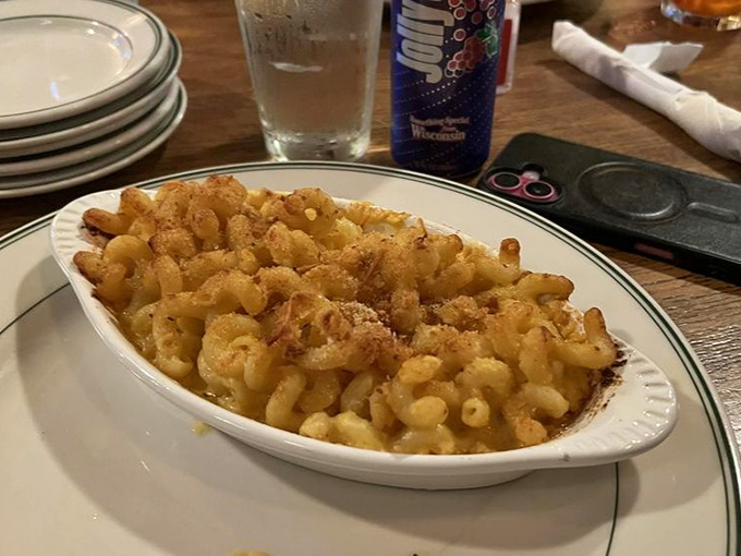 Mac and cheese perfection in its natural habitat &ndash; a simple oval dish that transforms humble ingredients into the comfort food equivalent of a warm hug.