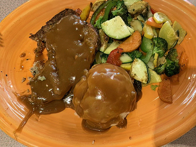 This meatloaf doesn't just sit on the plate &ndash; it commands attention with its rich gravy cascading down the sides like a savory waterfall of happiness.