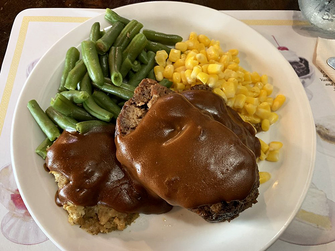 Behold the meatloaf that launched a thousand return visits. Draped in gravy with sides that know their supporting role but steal scenes anyway.