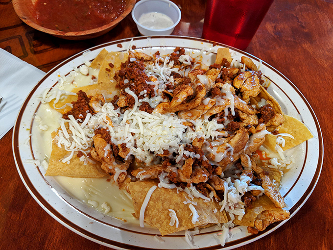 Behold the nacho mothership! Layers of chicken, beef, and cheese creating what can only be described as a tortilla chip's ultimate destiny.