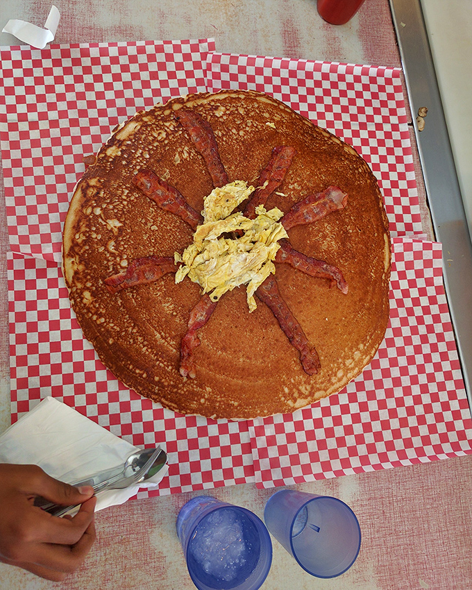 Behold the pancake sunburst! Golden-brown perfection with bacon rays radiating from a buttery center &ndash; breakfast architecture at its finest.