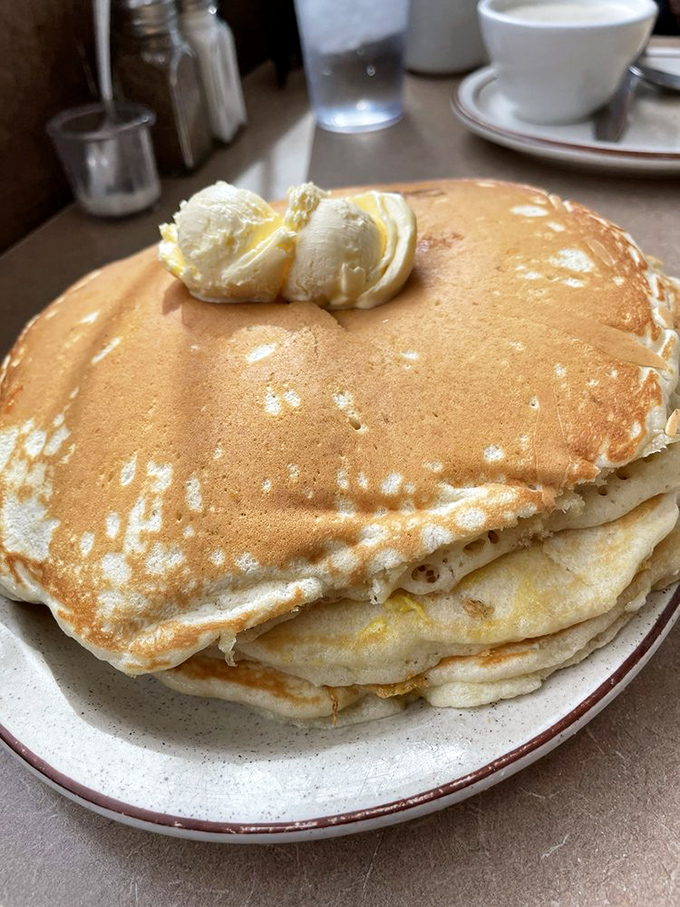 Behold the golden stack of joy! These pancakes aren't just breakfast, they're edible sunshine with butter melting like a slow-motion food commercial.