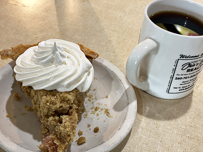 A slice of pumpkin pie with a mountain of whipped cream &ndash; proof that sometimes the best things in life require two hands and zero shame.