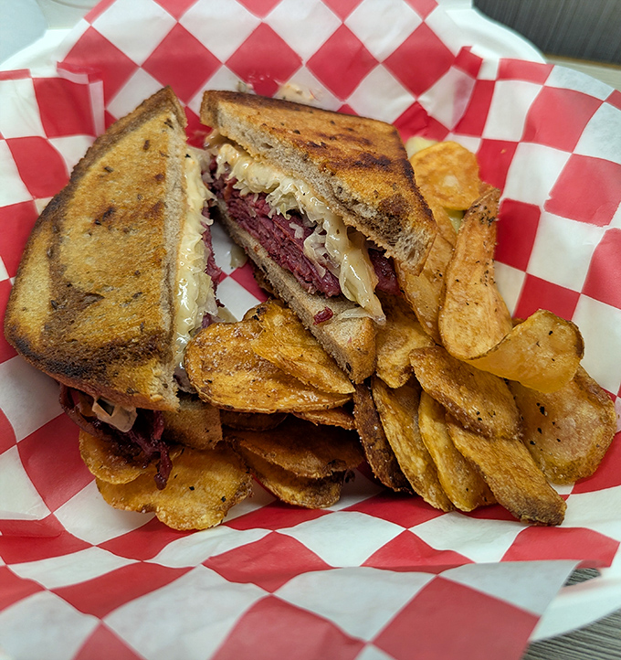 Behold the star of the show: a perfectly grilled Reuben with house-made chips. That melty cheese pull is the food equivalent of a standing ovation.
