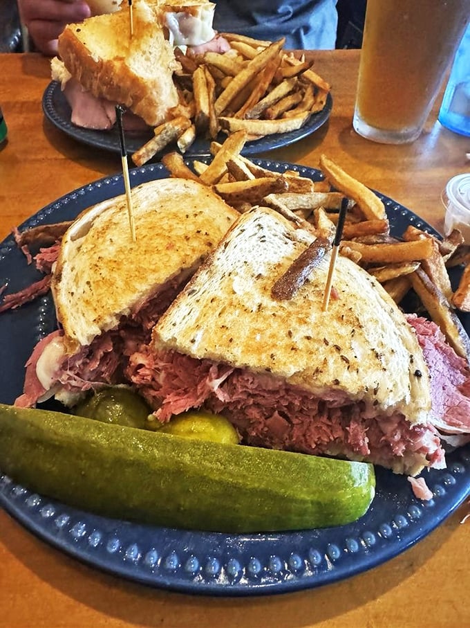Behold the Reuben in all its glory! Corned beef stacked higher than my college debt, with sauerkraut and Swiss creating perfect harmony.