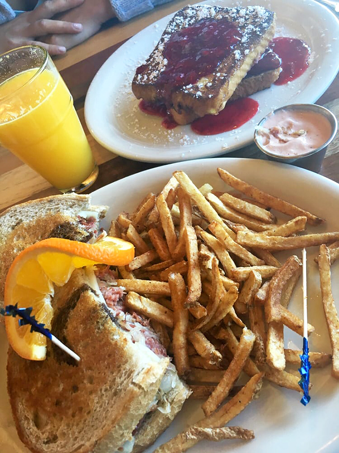 Sandwich architecture at its finest! Golden fries stacked like Lincoln Logs beside a sandwich that demands a strategic eating plan.
