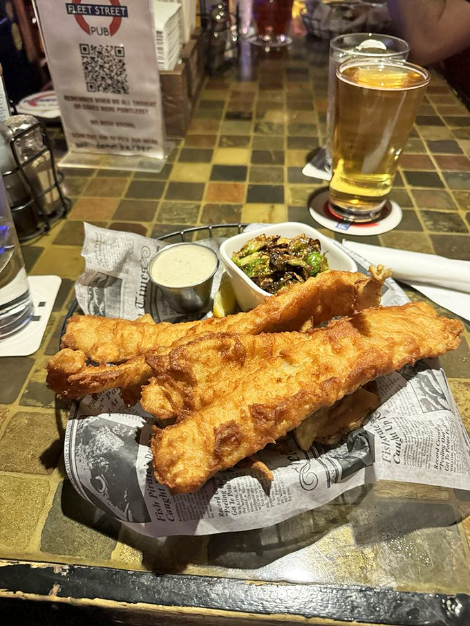 Golden-battered fish that shatters with each bite, paired with a pint that catches the light just right. British comfort food that speaks a universal language.