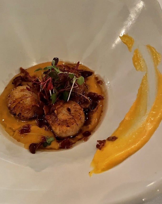 These golden scallops arrive like little medallions of ocean perfection, seared to absolute culinary bliss.