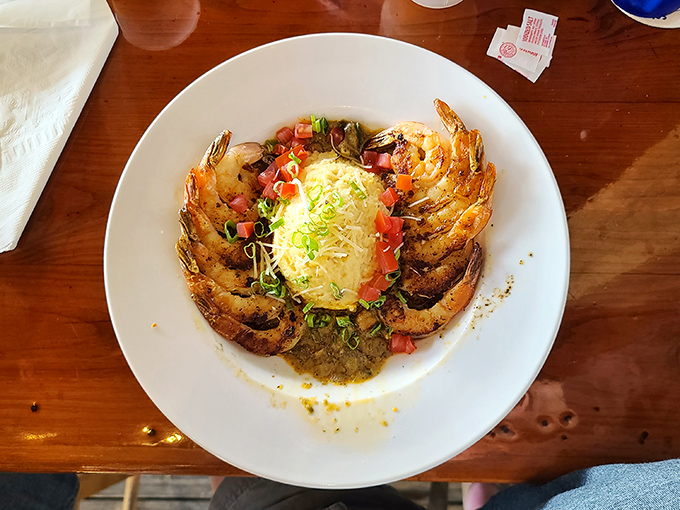 The legendary shrimp and grits that launched a thousand road trips – plump Gulf shrimp circling creamy cheese grits like delicious sentinels guarding treasure.